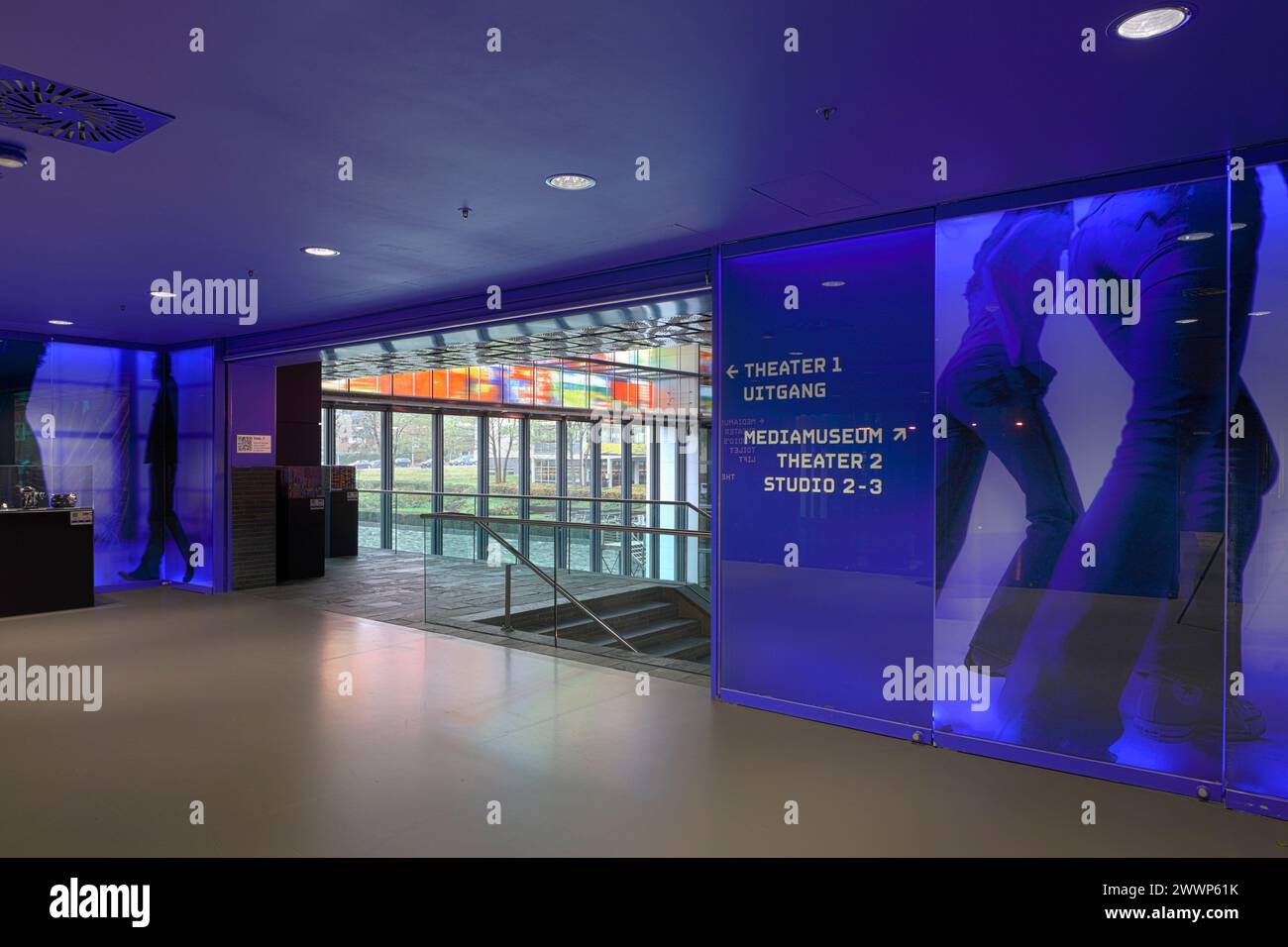 Blue painted corridor overlooking atrium, with staircase. Dutch ...