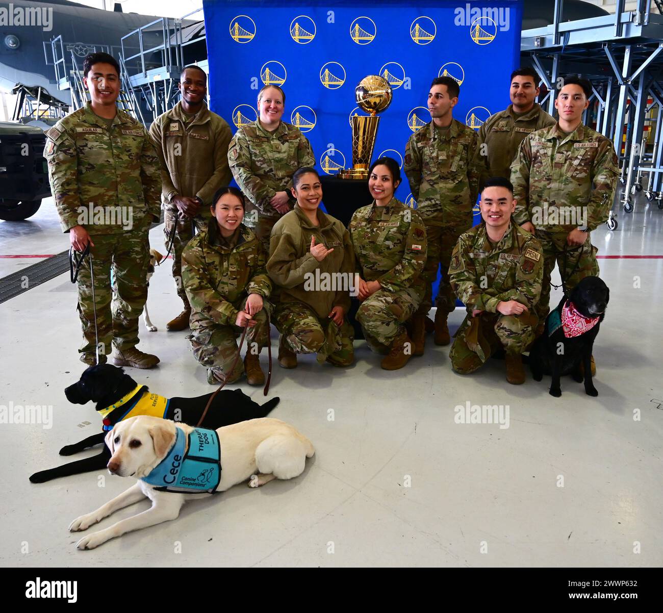 U.S. Air Force Airmen take a group photo with service dogs and the NBA ...