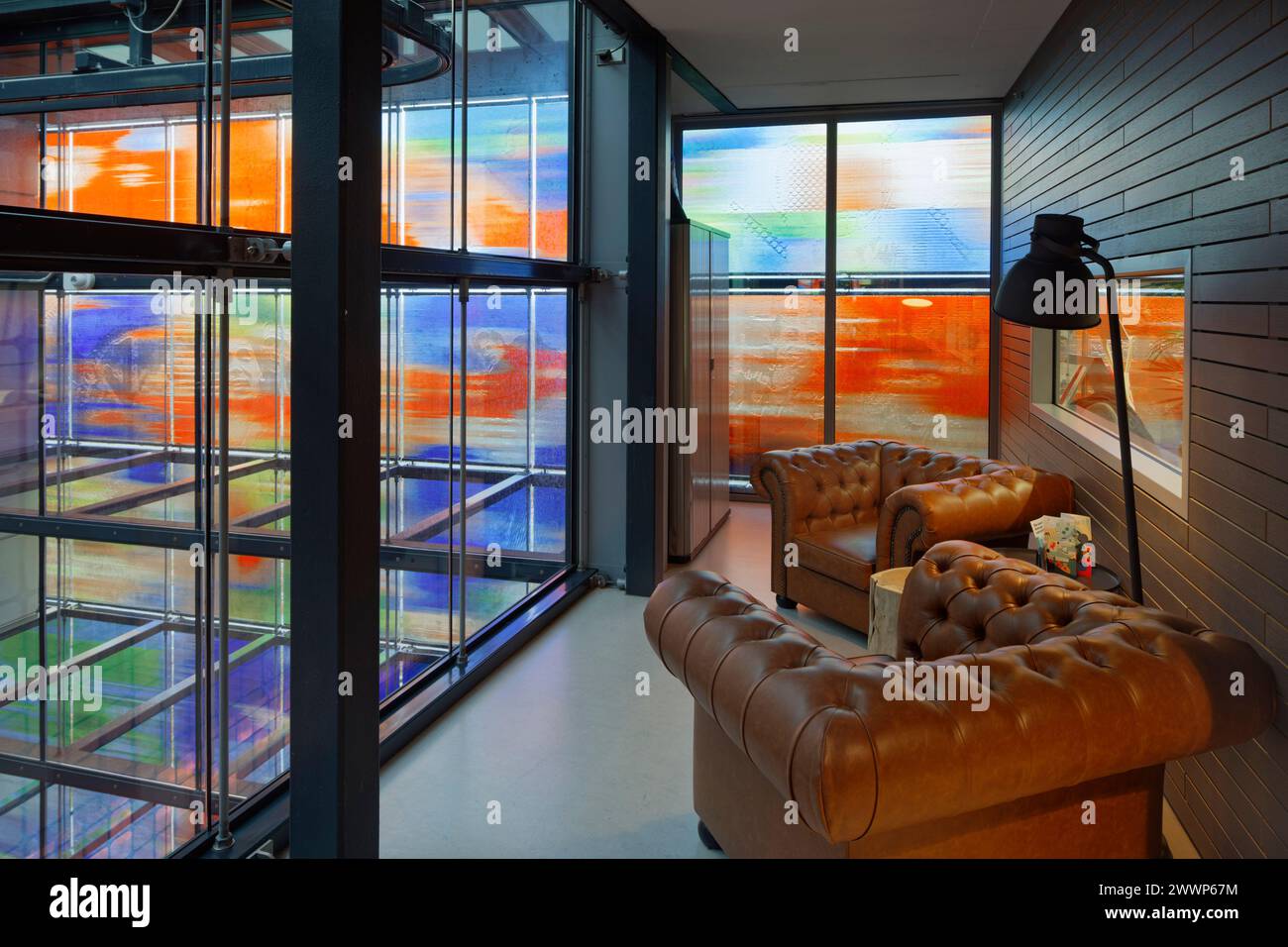 Seating area in corridor in office area, with club armchairs, and ...