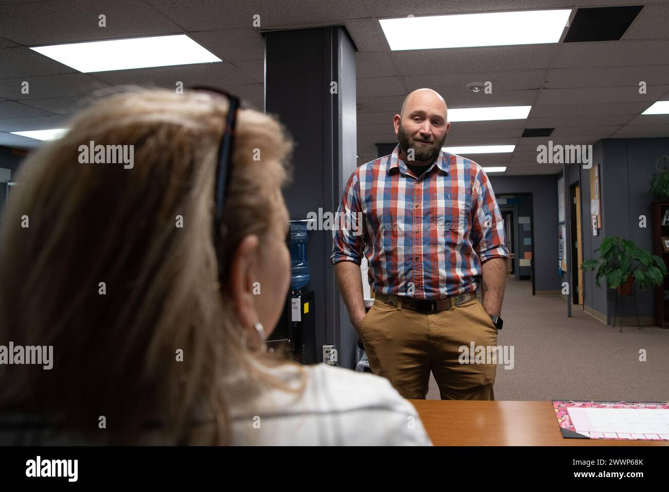 Community Resilience Coordinator Adam Hooven (right) speaks with co ...