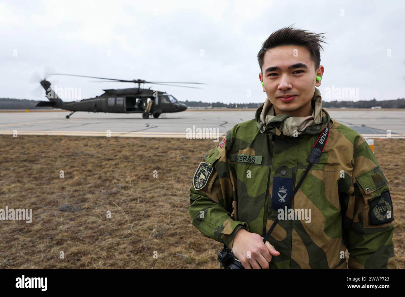 Norwegian Air Force Pvt. Tor-Magnus Øverås stands in front of a UH-60 ...