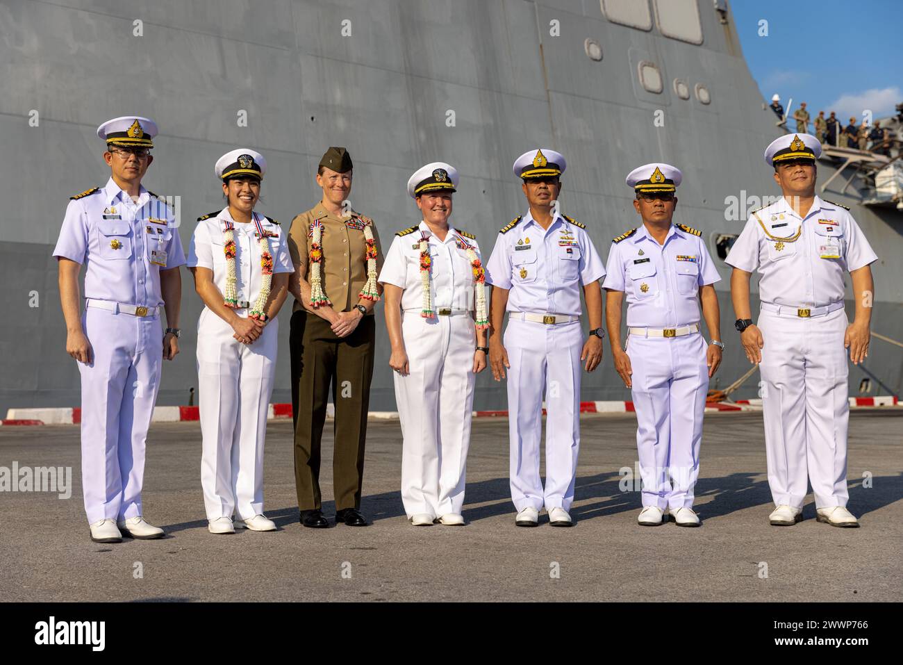 U.S. Navy Capt. Michel Brandt, center, commanding officer of the ...