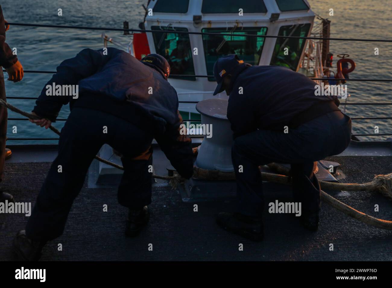 240202-N-JM579-1085 ROTA, Spain (Feb. 2, 2024) Sailors tie-up a tug ...