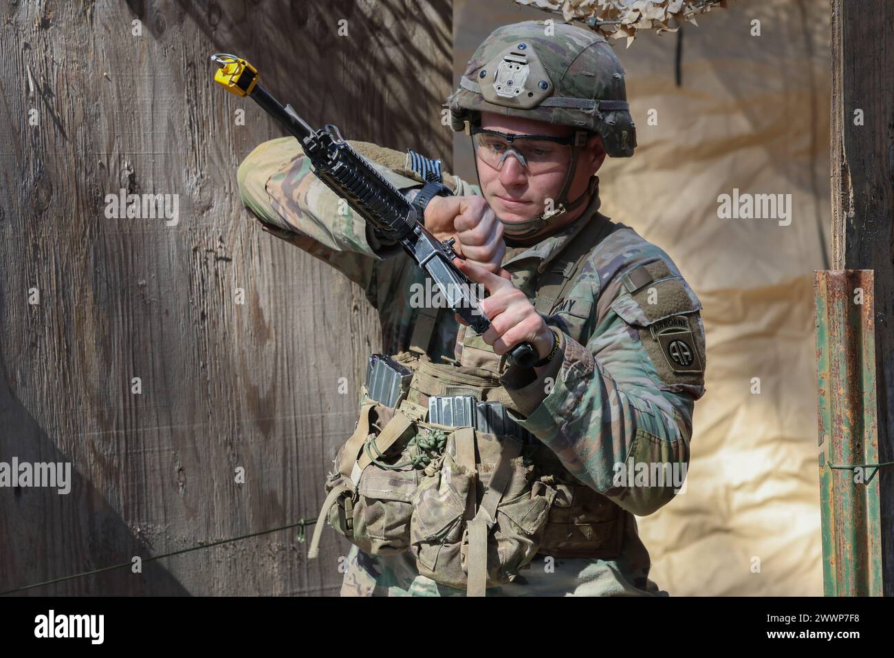 A U.S. Army soldier assigned to the 82nd Airborne Division clears an M4 ...