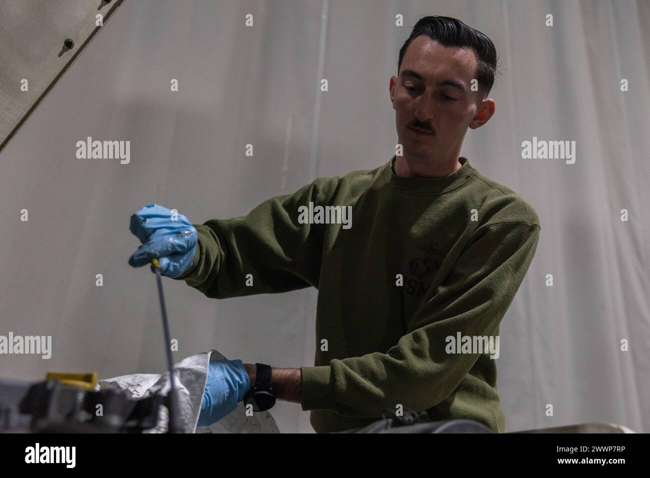 U.S. Marine Corps Cpl. Tron Rhodes, an aircraft maintenance support ...