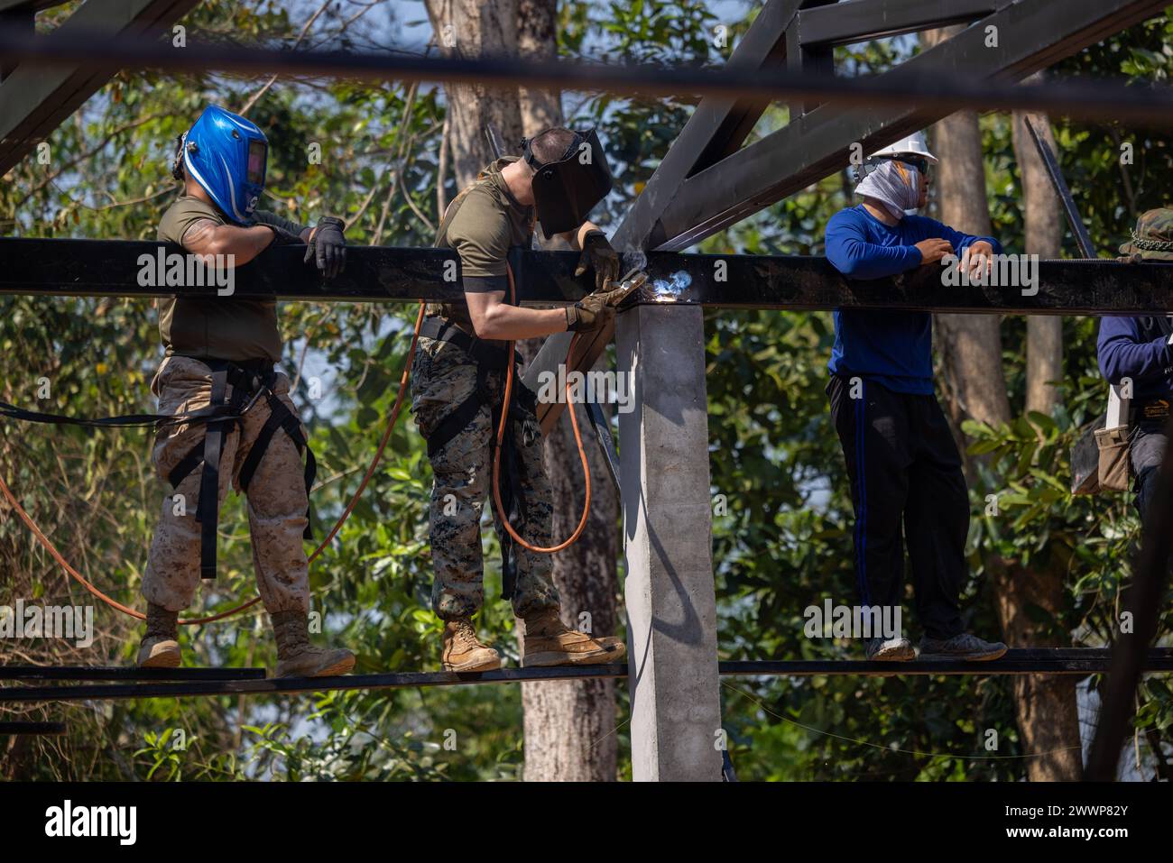 U.S. Marine Corps Sgt. Damion Lopez, left, a metal worker, and resident ...