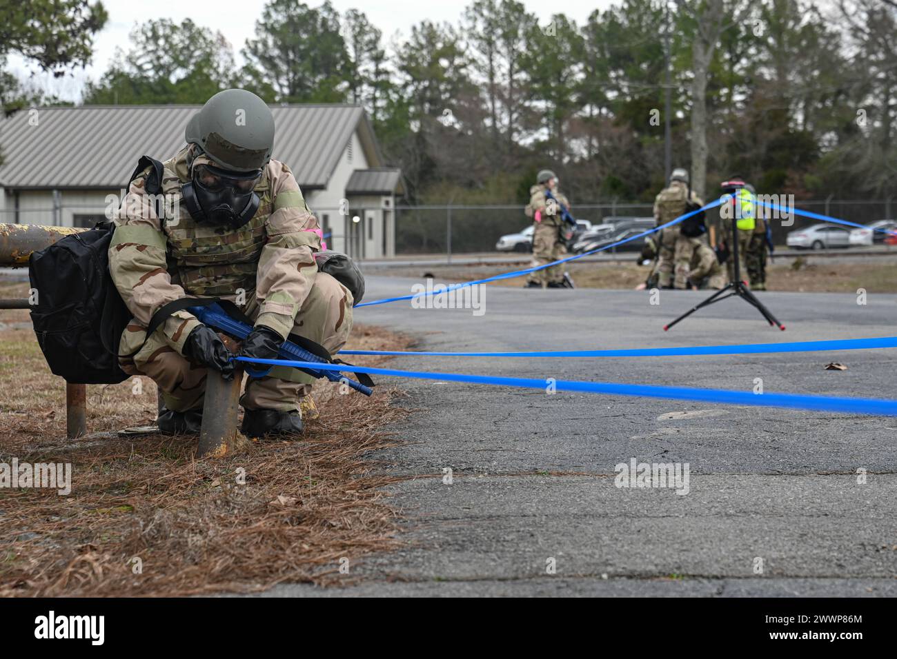 A Team Little Rock Airman prepare the perimeter around an unexploded ...