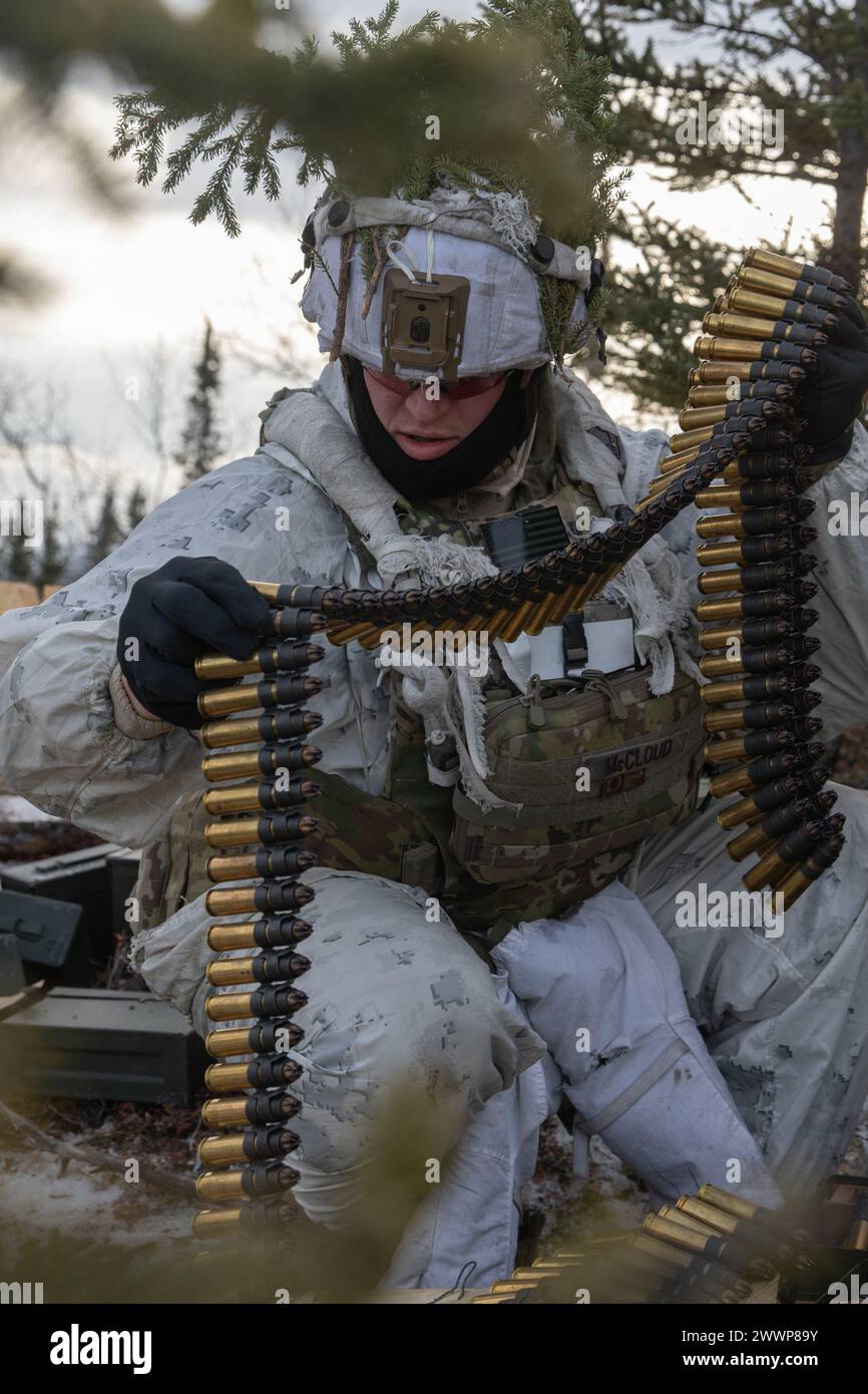 A U.S. Soldier gets ammunition ready for the M2A1 machine gun while ...