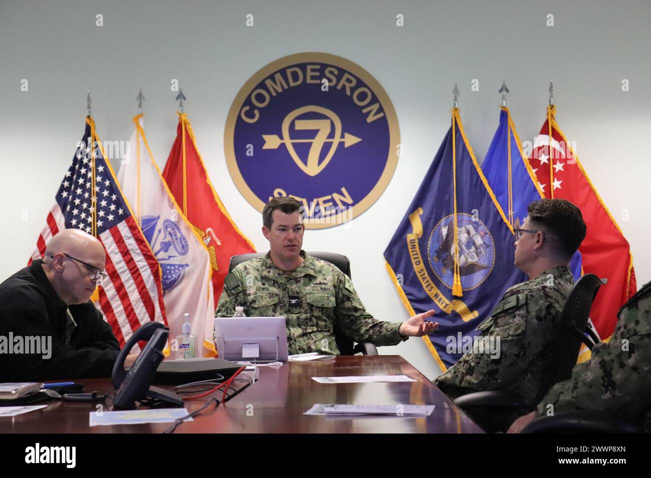 SINGAPORE (Feb. 26, 2024) – Capt. Sean Lewis (center), from Queens, New ...