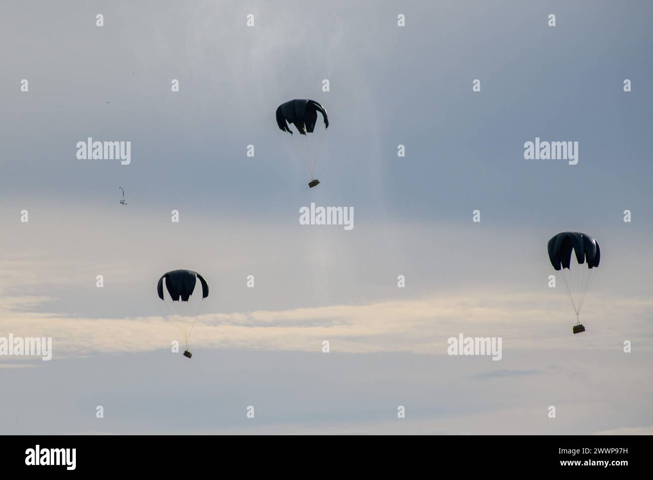 Three bundles descend onto Chièvres Drop Zone as U.S. Airmen with the ...