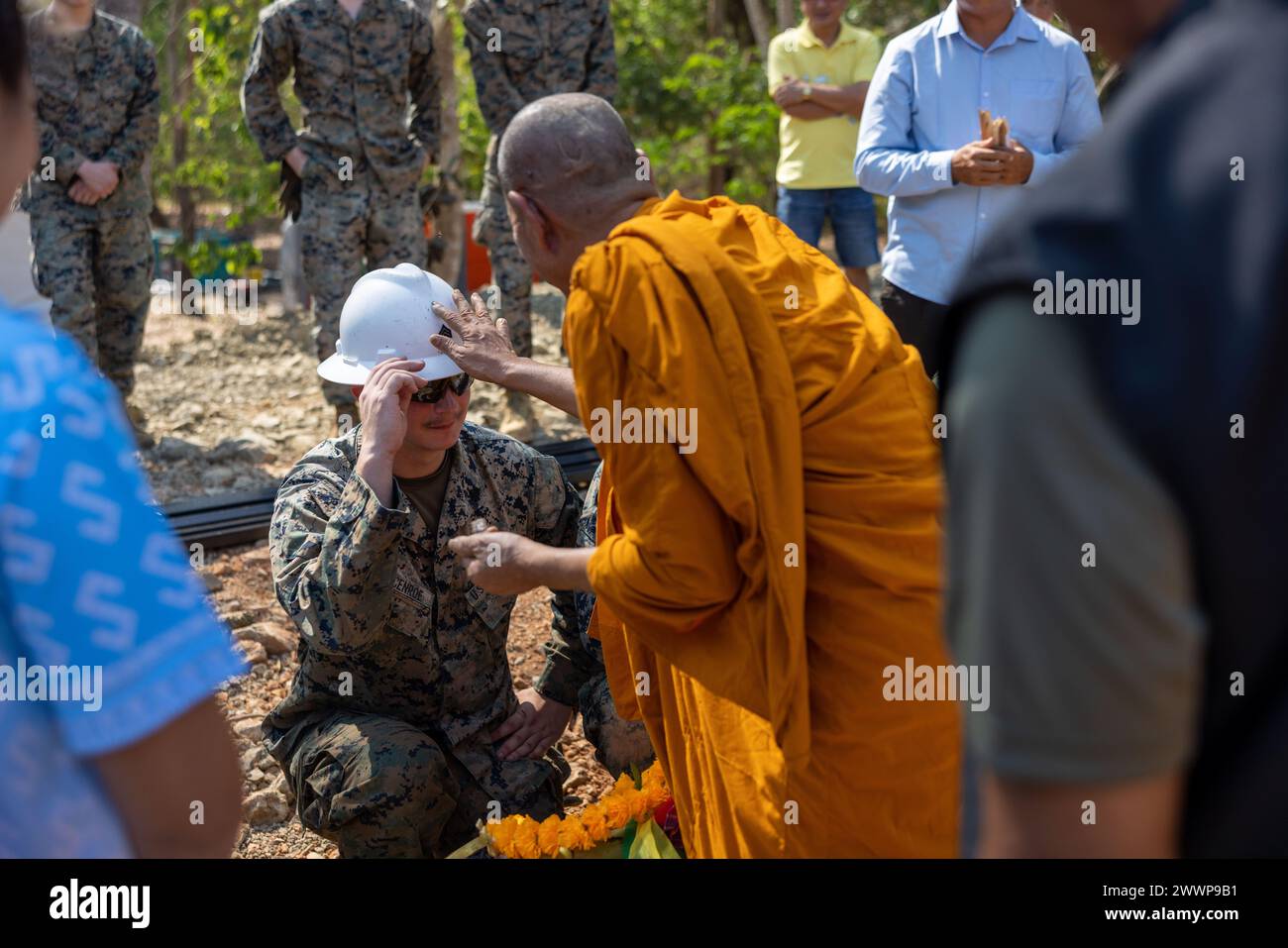 A Buddhist monk blesses U.S. Marine Corps Sgt. Joshua Mcenroe, a combat ...