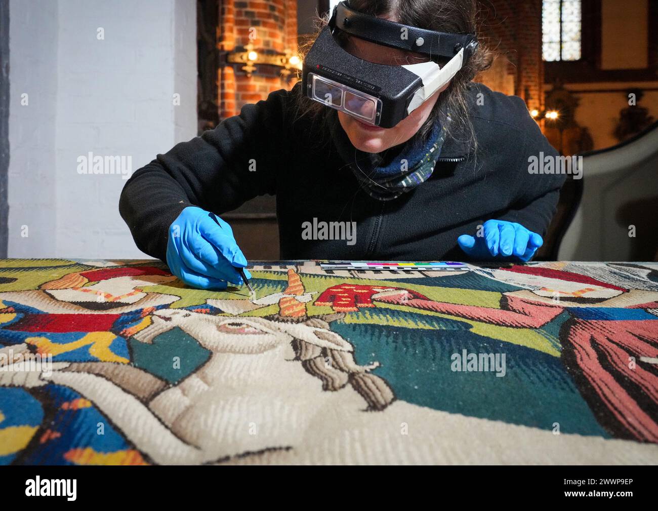 25 March 2024, Brandenburg, Brandenburg/Havel: Textile restorer Julia ...