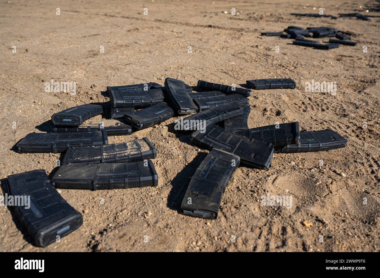 Empty magazines lay in the dirt after an M4 carbine shooting drill ...