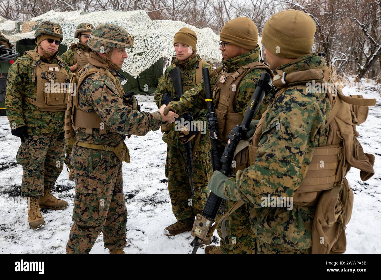 U.S. Marine Corps Brigadier General Adam Chalkley, left, the commanding ...