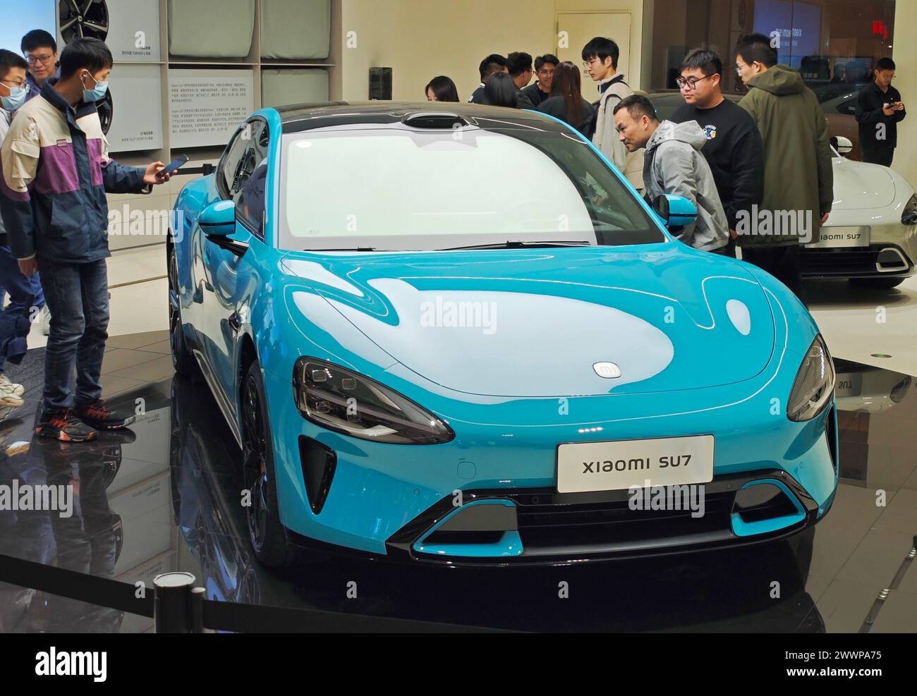 SHANGHAI, CHINA - MARCH 25, 2024 - Customers learn about the Xiaomi SU7 electric supercar at a ...