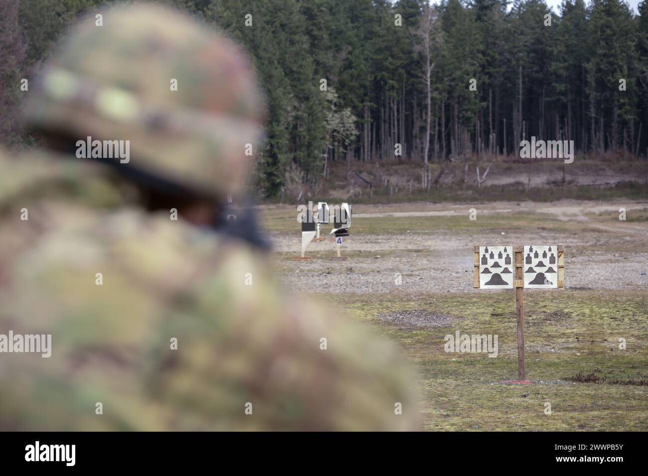 A U.S. Army Soldier aims toward targets at range 14 on Joint Base Lewis ...
