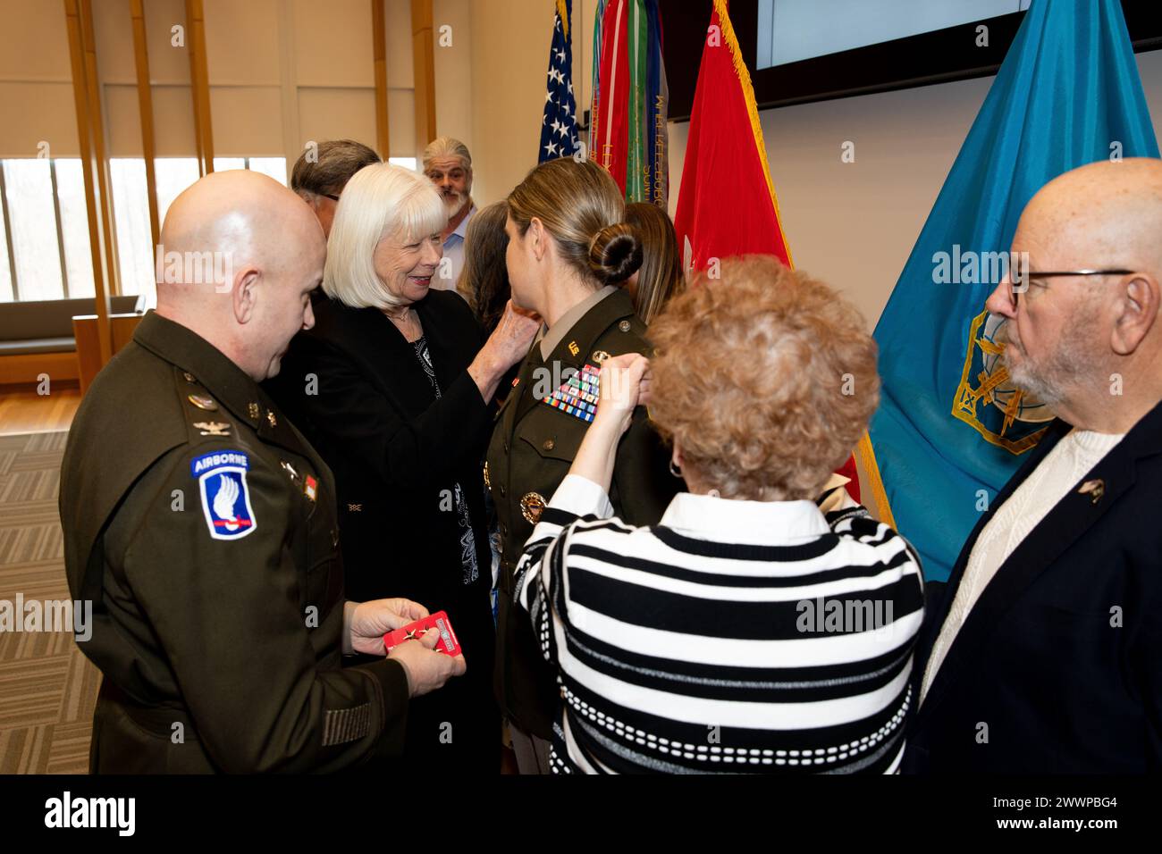 Family members pin brigadier general rank on to Brig. Gen. Melissa Adamski, commander, Military ...