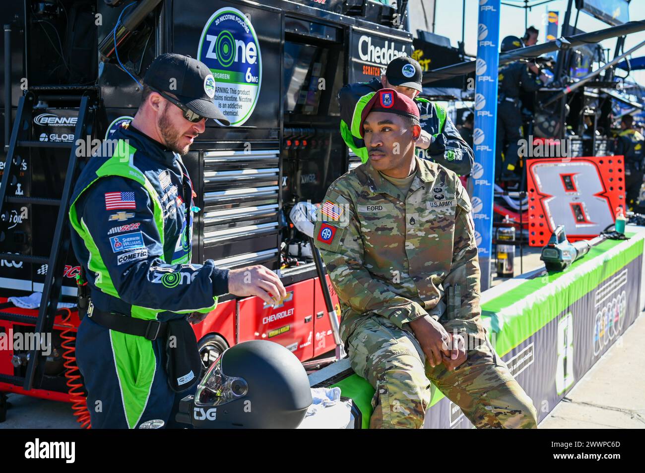 Staff Sergeant William Ford speaks with a member of the pit crew during ...
