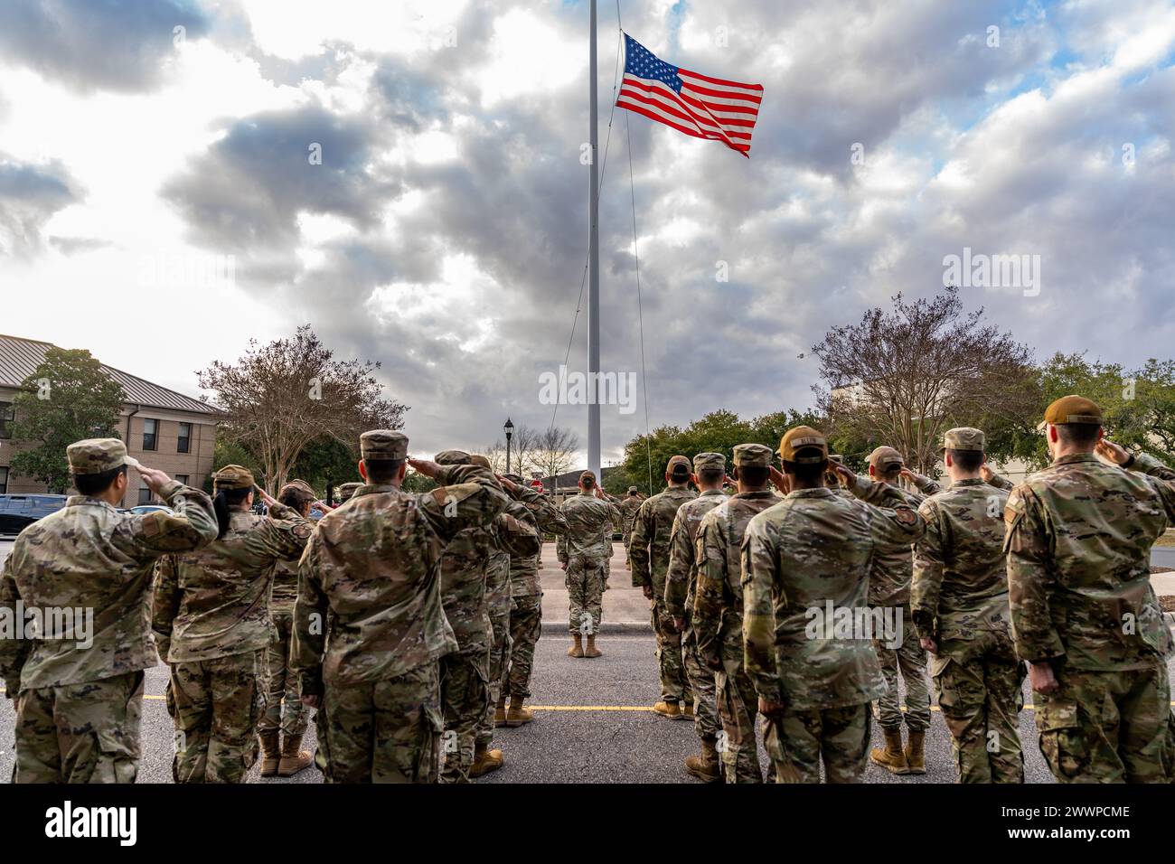U.S. Airmen present arms as the U.S. flag is lowered during the fallen ...