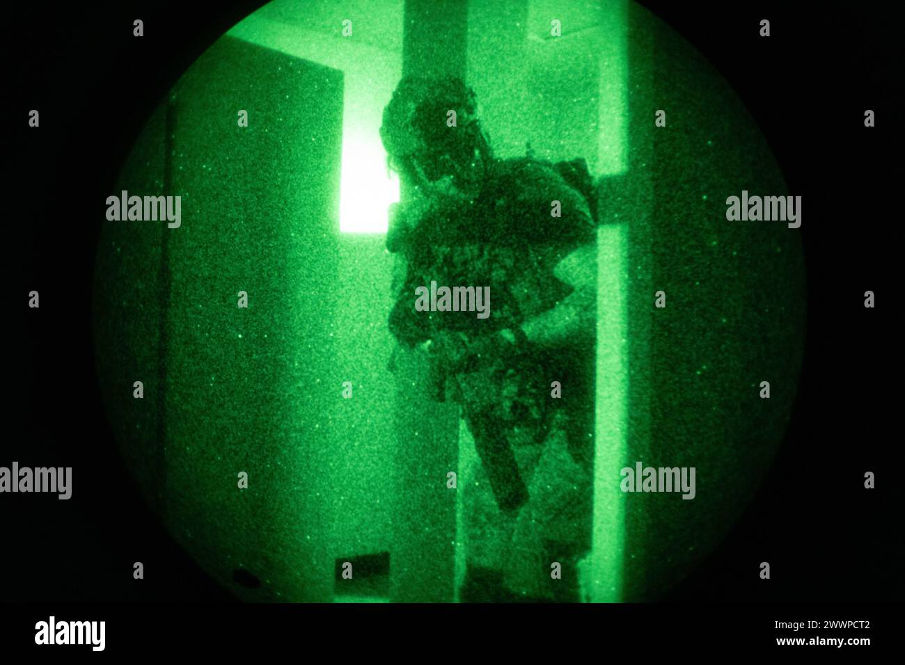 A Norwegian Naval Special Operations Commando clears a room at night ...