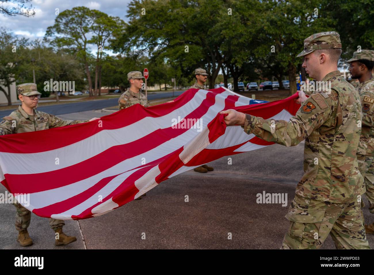 U.S. Airmen fold the U.S. flag during the fallen warrior retreat ...