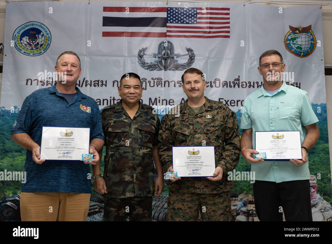 U.S. Marine Corps Gunnery Sgt. Pierce Draper, center right, the ...