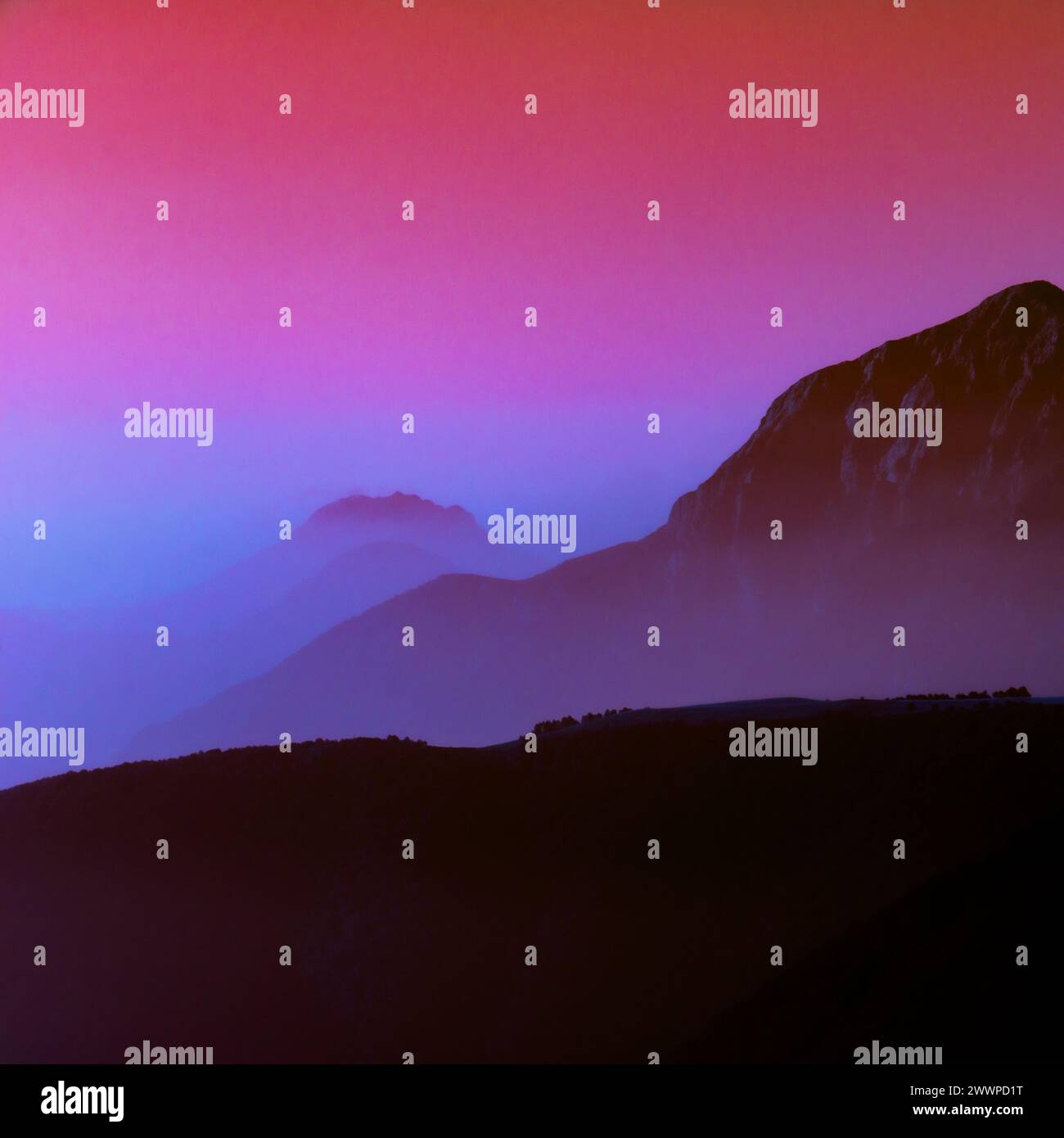 Spectacular mountain ranges silhouettes in shade of purple and black ...