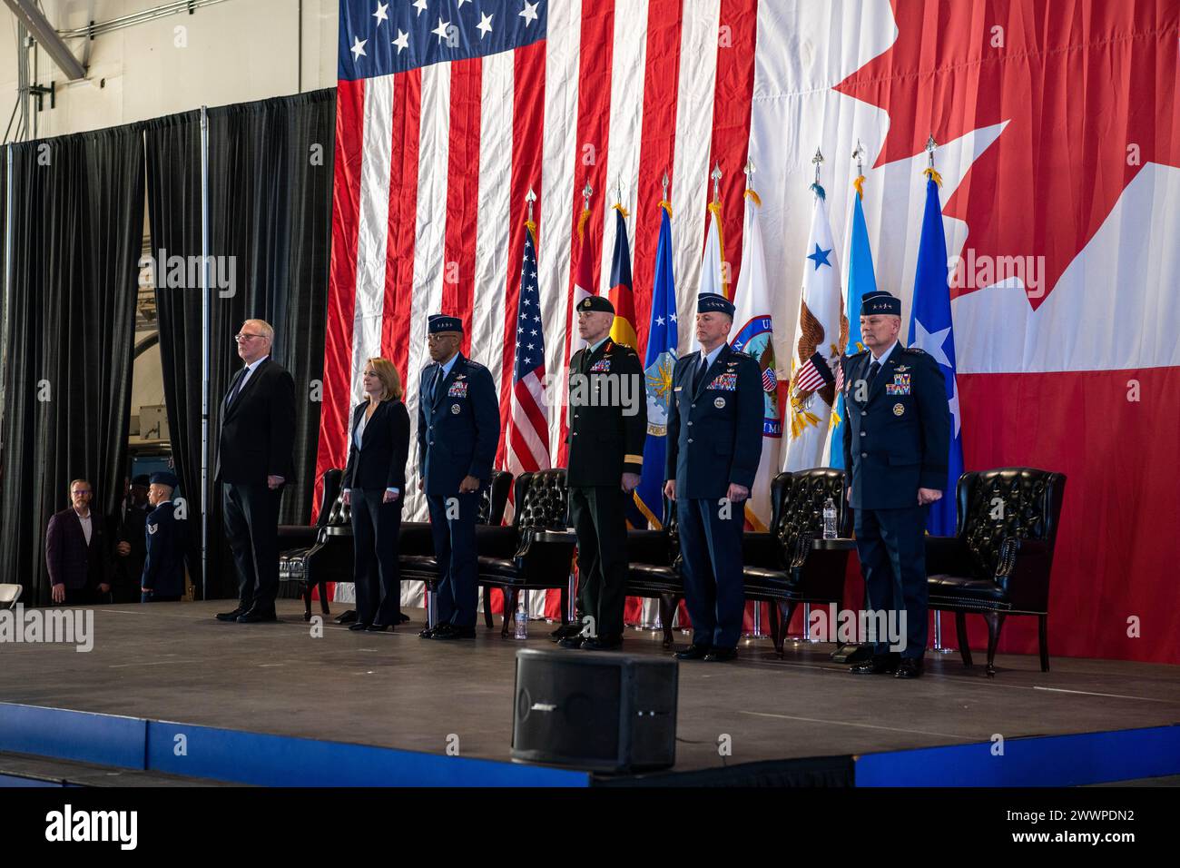 Members of the official party stand at attention during the playing of ...