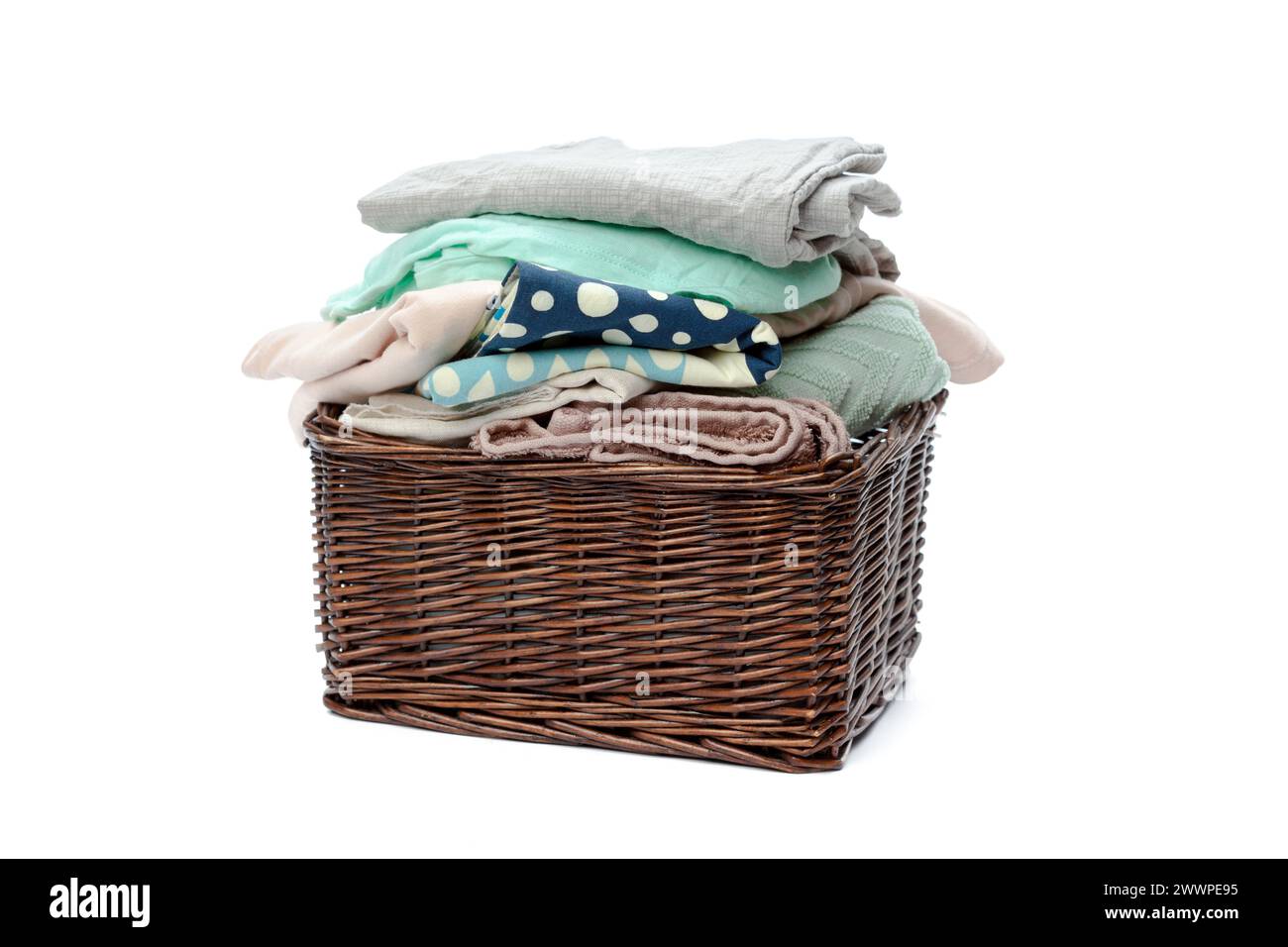 Clothes in a laundry wooden basket isolated on white background Stock ...