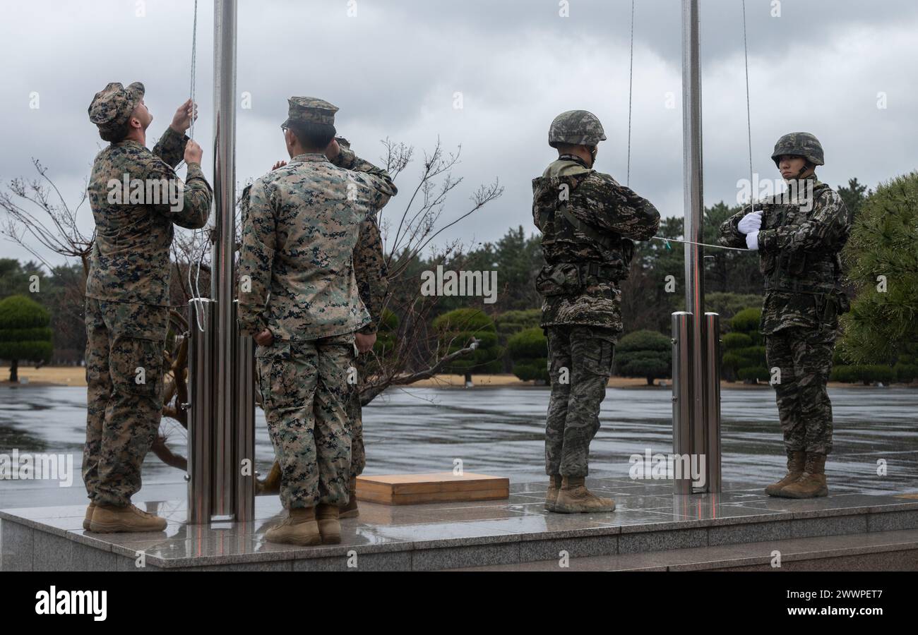 U.S. Marines with 1st Marine Division lower the U.S. flag during a ...