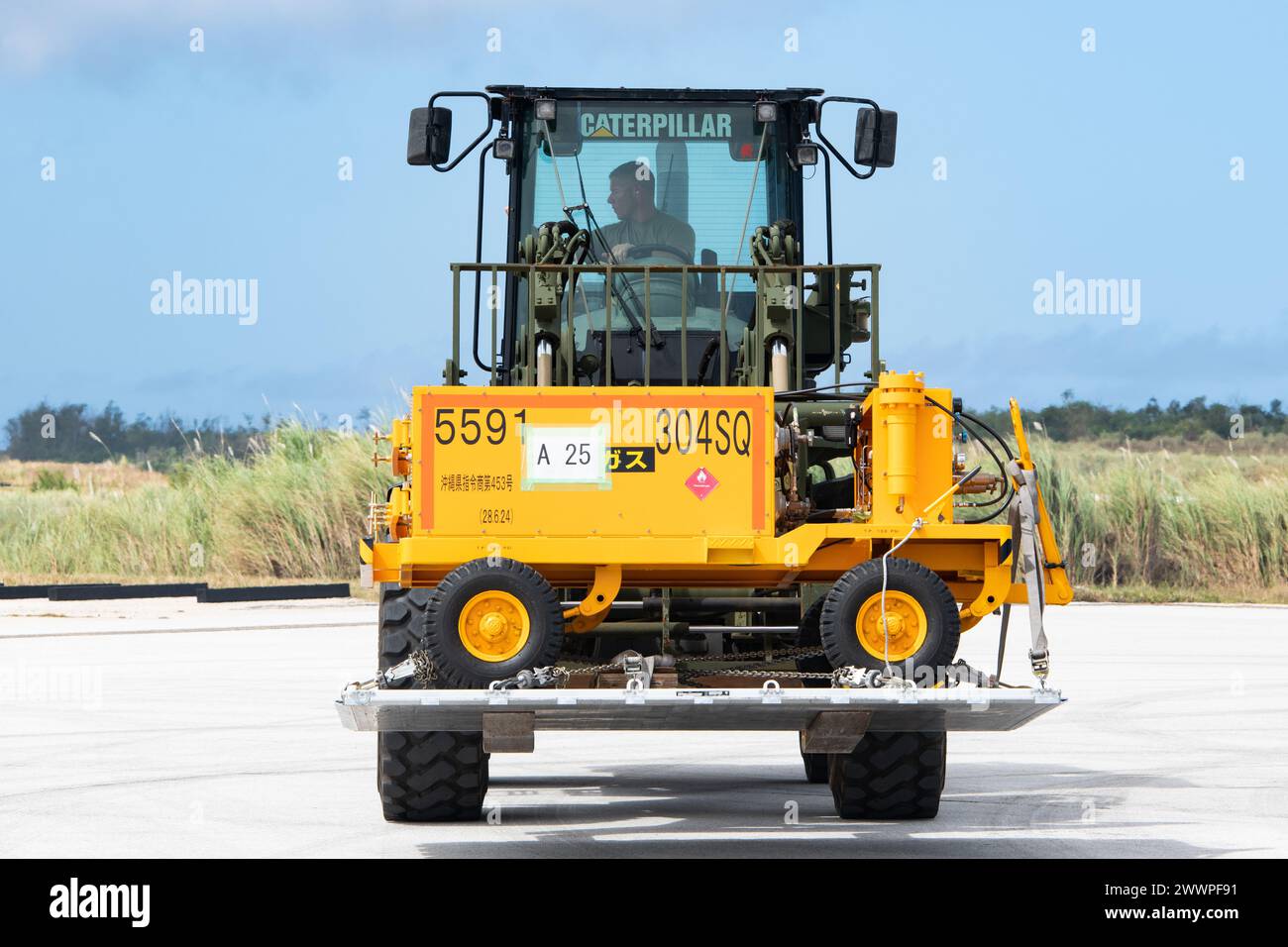 A U.S. Air Force transport airman drives a forklift with a cargo pallet ...