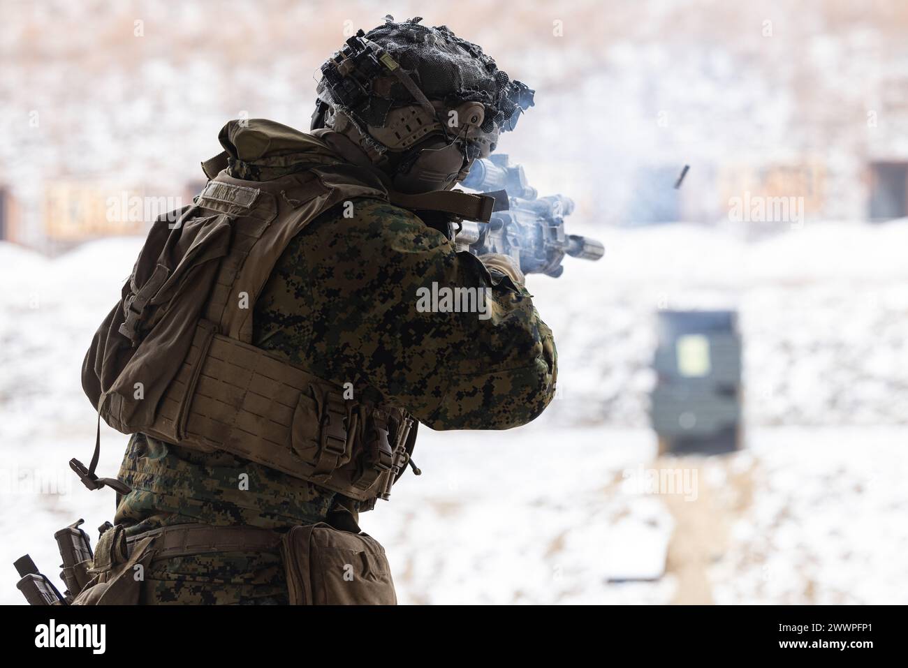 U.S. Marine Corps Lance Cpl. Brian Morris fires an M27 Infantry ...