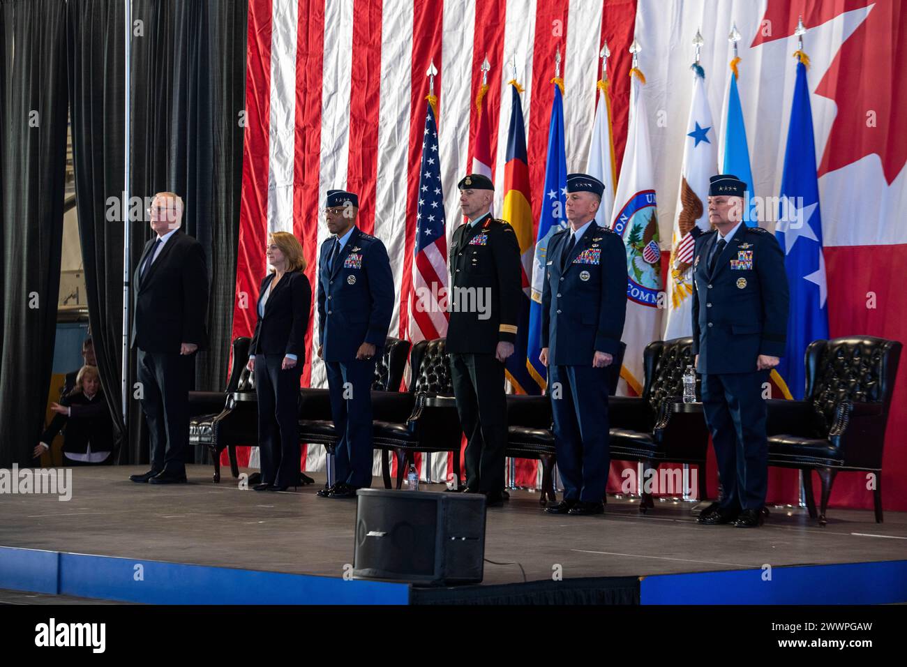 Members of the official party stand at attention during the playing of ...