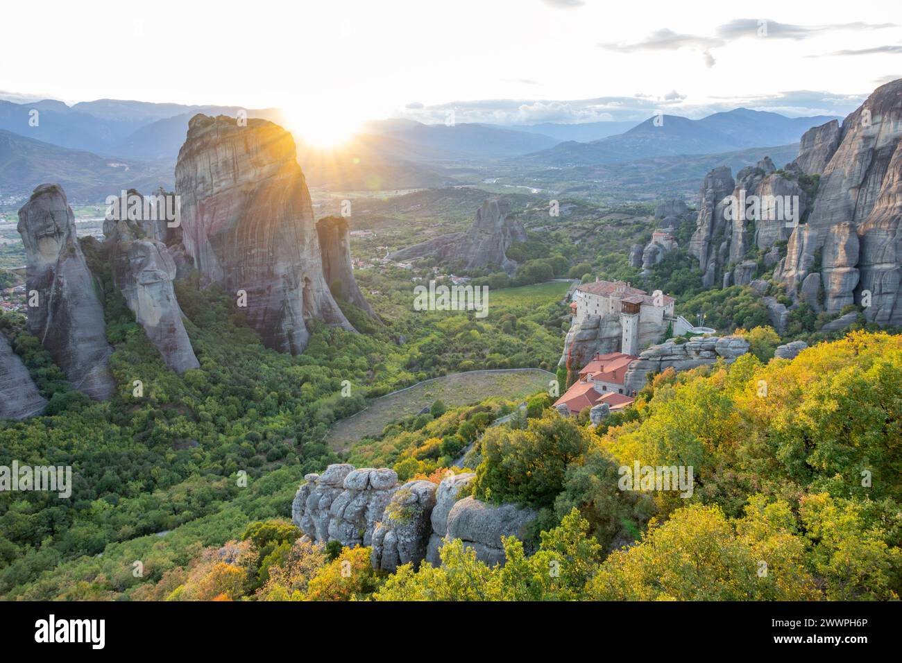 Greece. Sunset rays over the green valley in Meteora. Monastery on the ...
