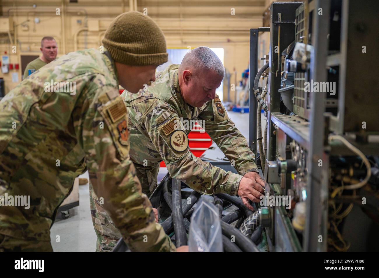 Chief Master Sgt. Justin Apticar (center), 19th Air Force command chief ...