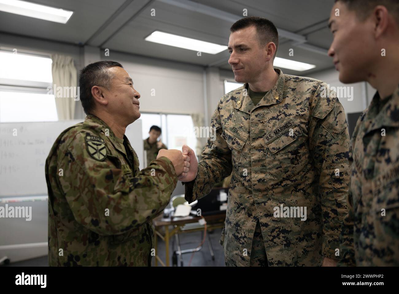 U.S. Marine Corps Maj. Zachary Fox, right, the current operations ...