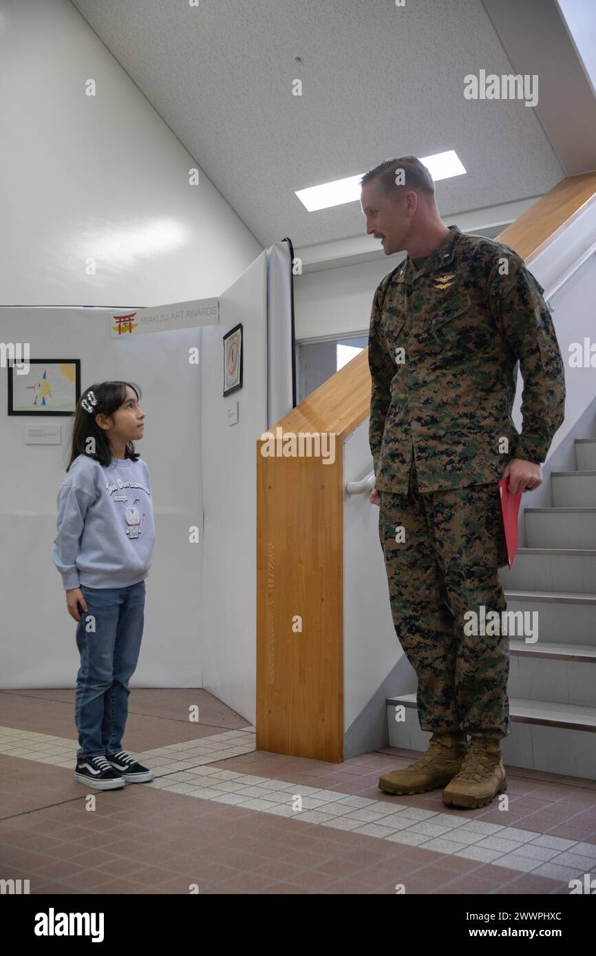 A student from Matthew C. Perry Primary School, left, describes her ...