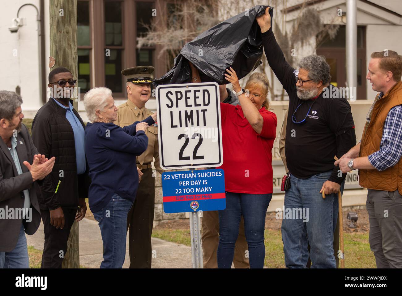 Key military and local community leaders unveil a new 22 mph sign at ...