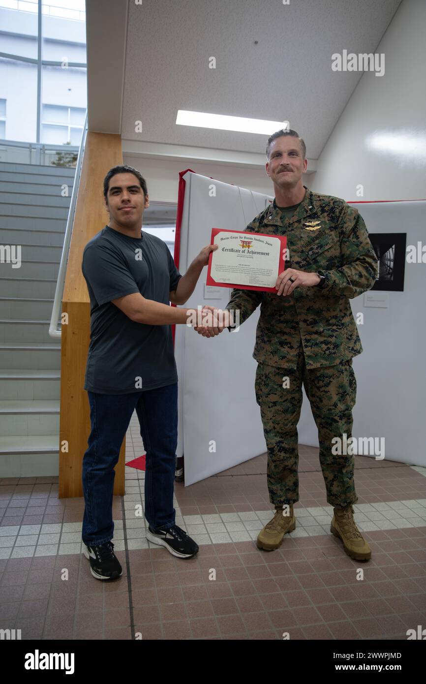 A student from Matthew C. Perry High School, left, poses for a picture ...