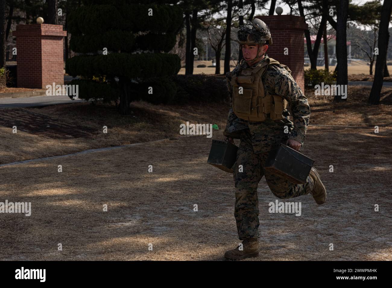 U.S. Marine Corps Lance Cpl. Brian Morris sprints with ammunition cans ...
