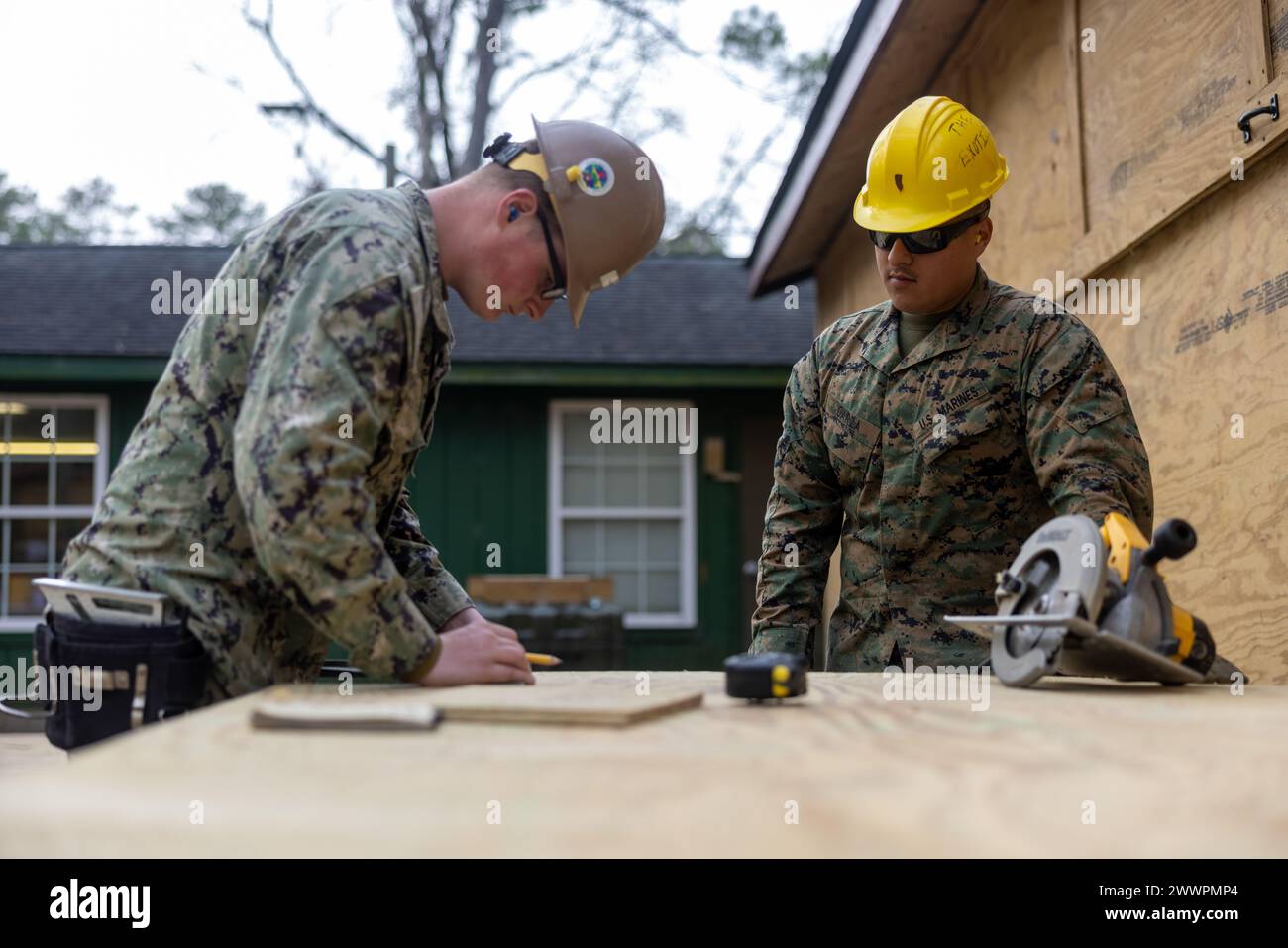 U.S. Navy Builder Construction Men Liam Murphy, left, with Naval Mobile ...