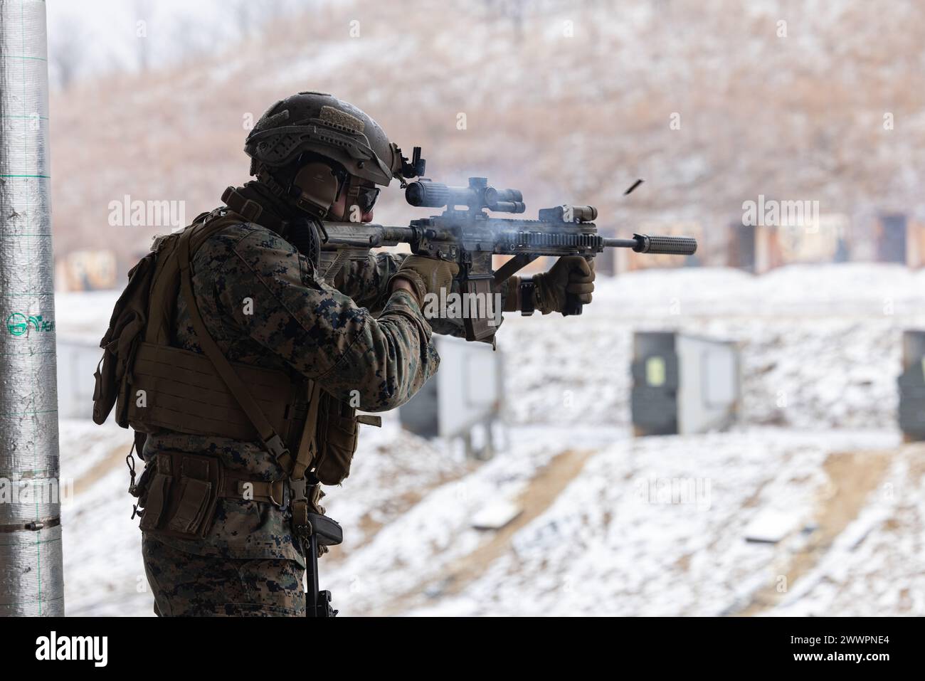 U.S. Marine Corps Lance Cpl. Hayden Sutton fires an M27 Infantry ...