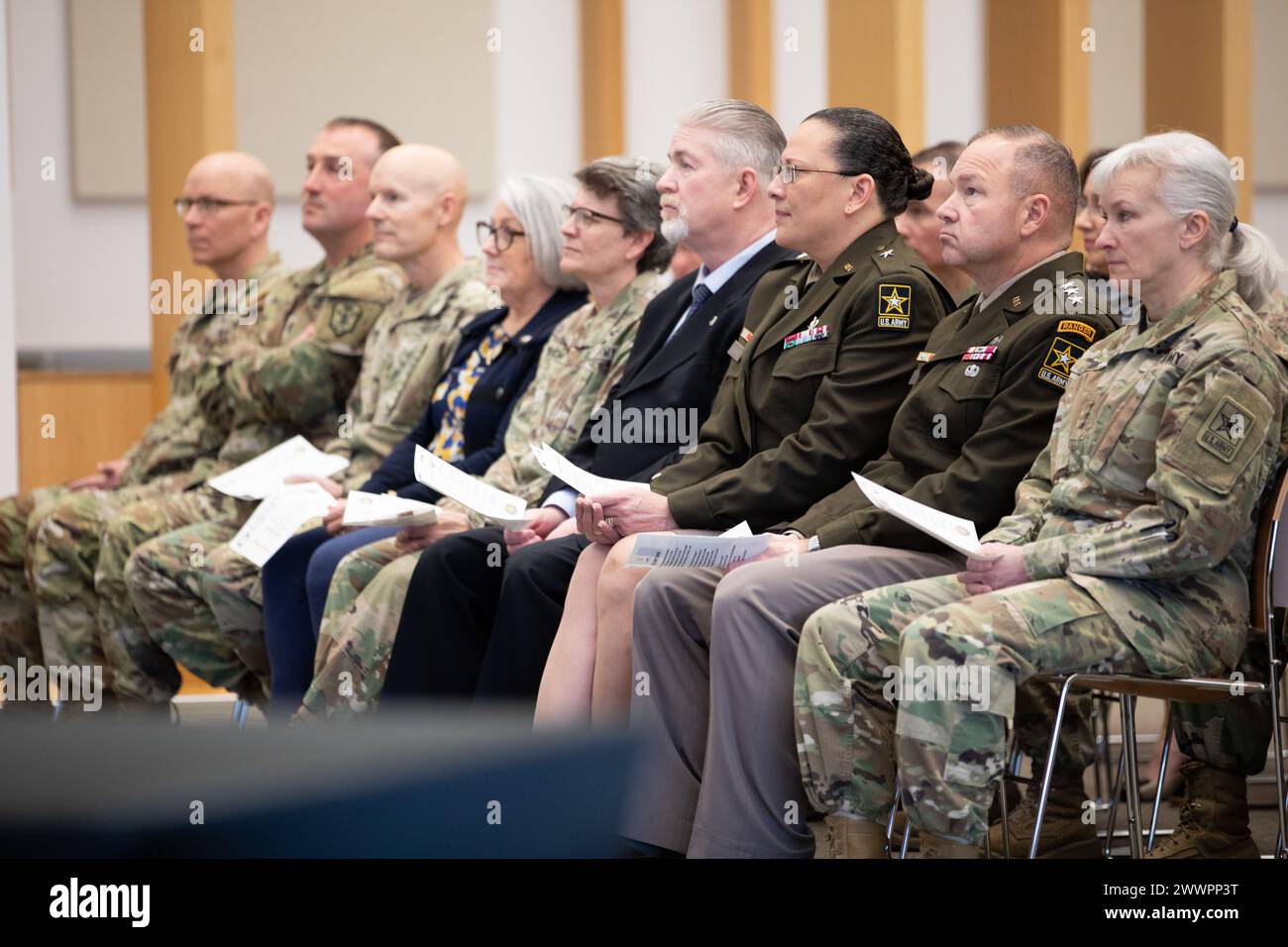 Distinguished visitors listen to a speech during a promotion ceremony ...