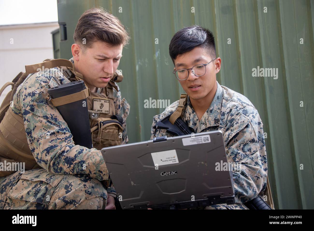 U.S. Marine Corps Sgt. Stetson Jansen, left, data systems administrator ...