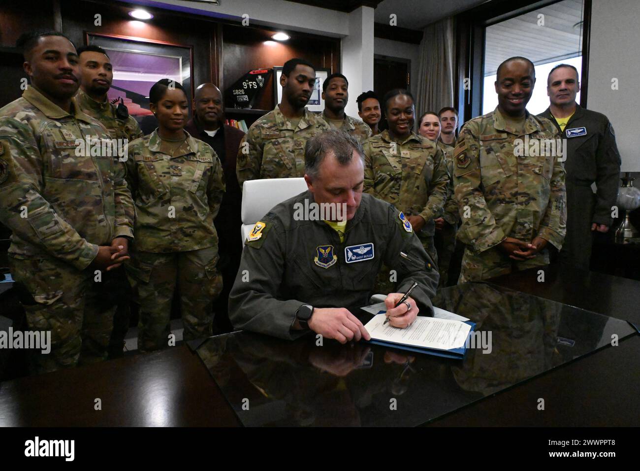 U.S. Air Force Col. Keith Butler, 509th Bomb Wing commander, signs the ...