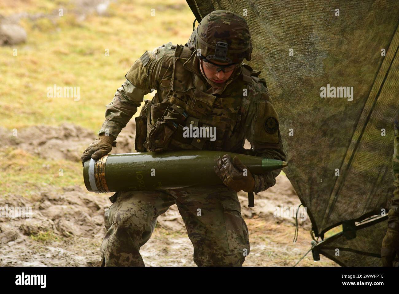 A U.S. Soldier assigned to B Battery, 2nd Cavalry Regiment Field Artillery Squadron, moves a ...