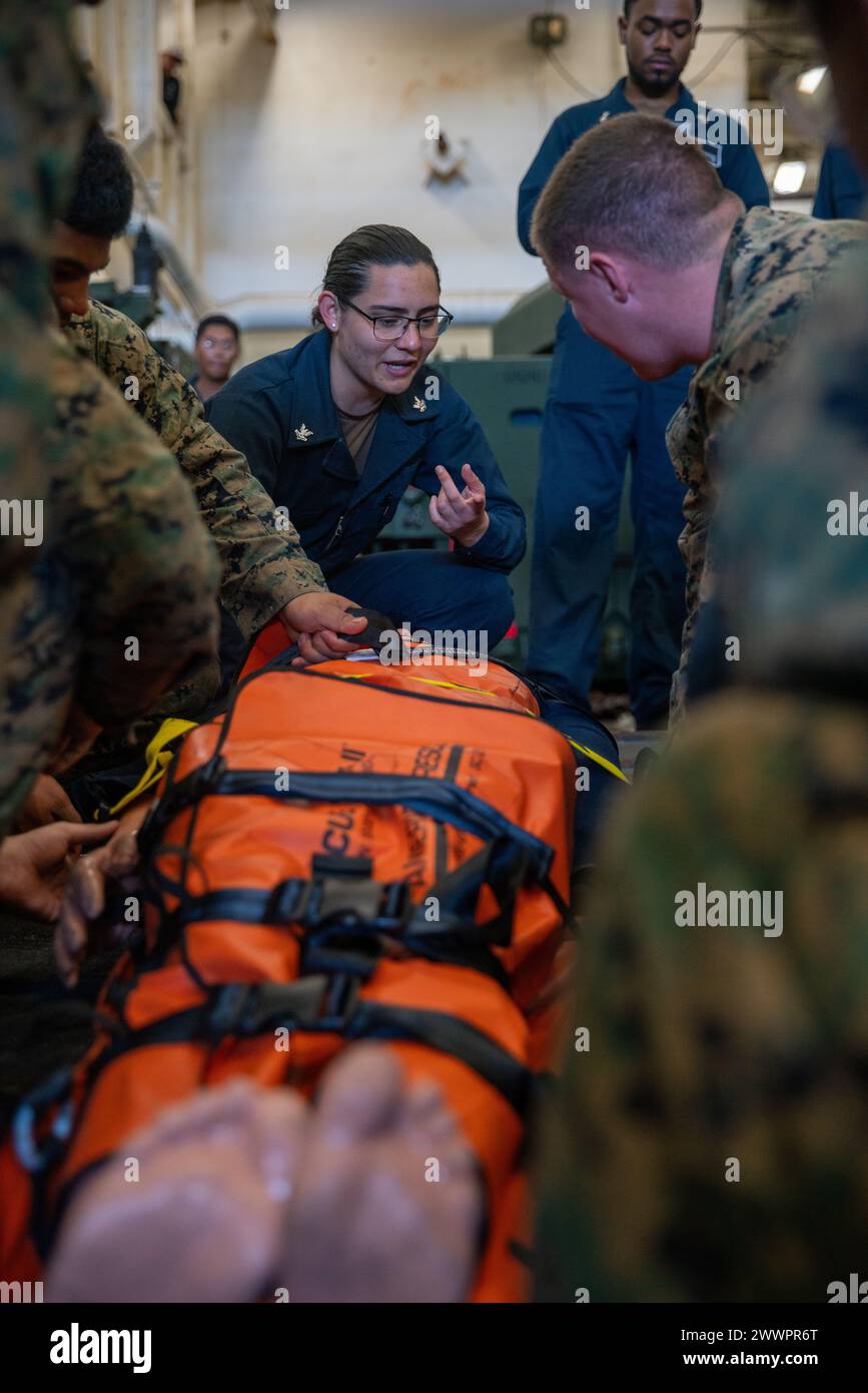 U.S. Navy Yeoman 2nd Class Andrea Mago, center, a native of Venezuela ...