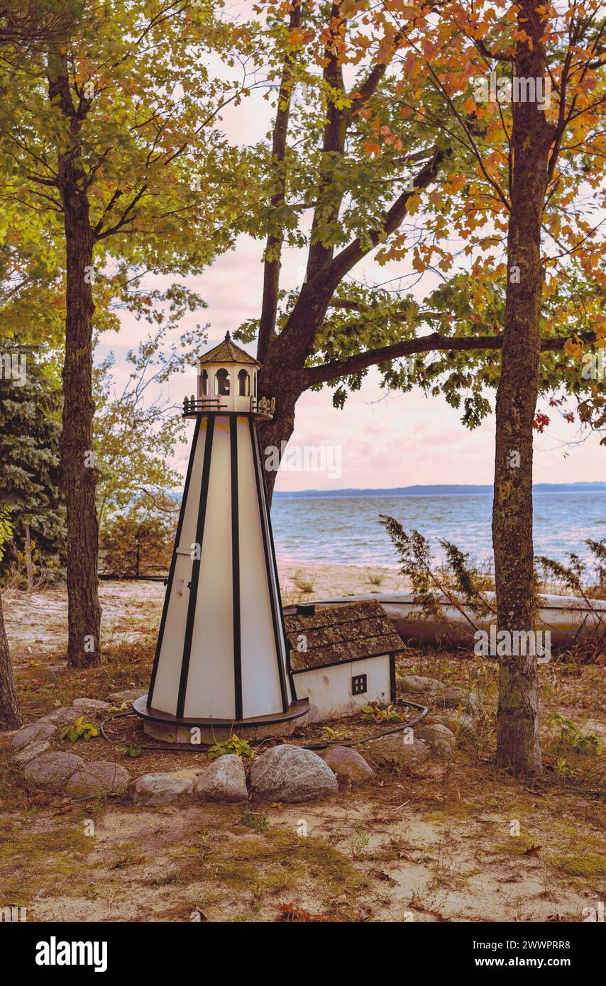 Small scale wood lighthouse sits on shore of Traverse Bay in Michigan ...