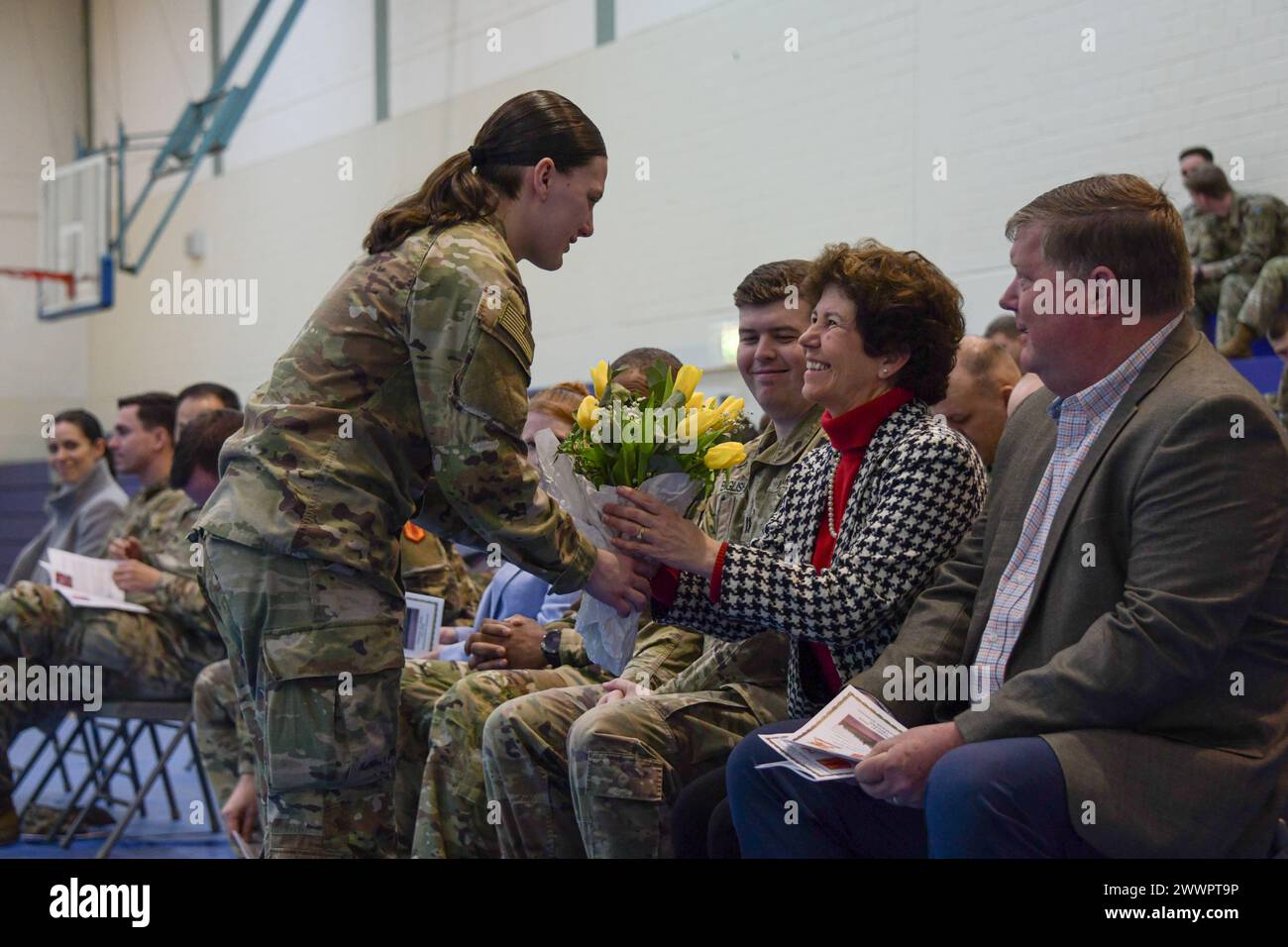 A bouquet of yellow roses is presented to Mrs. Connie English, mother ...