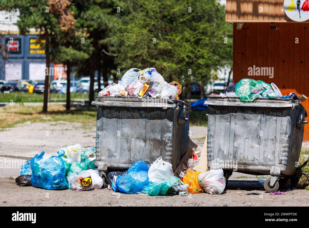 overfilled public trash bins at summer day in Bishkek, Kyrgyzstan Stock ...